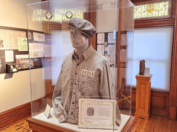 This prison uniform display, complete with inmate number, represents thousands who wore similar stripes while serving time at the reformatory.