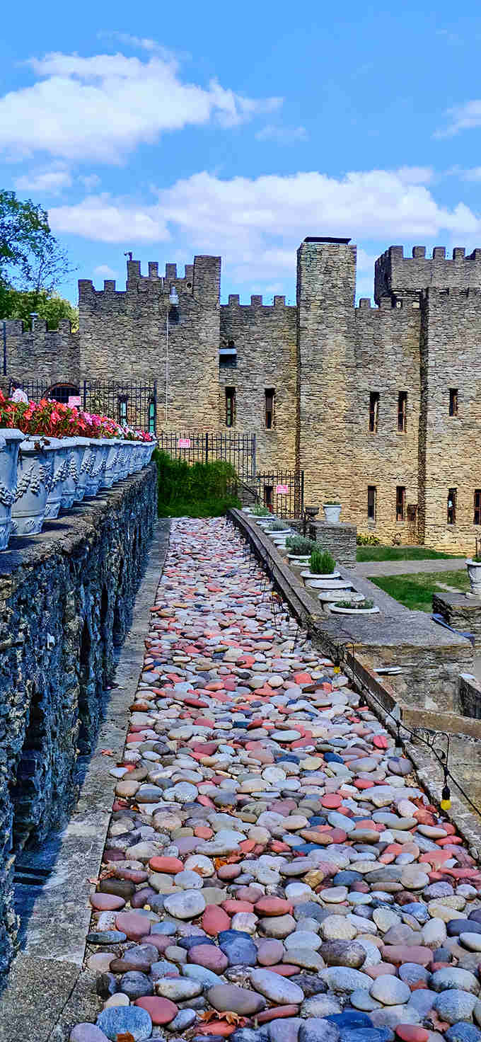 Colorful river stones form a pathway fit for royalty, their smooth surfaces polished by countless visitors' footsteps.