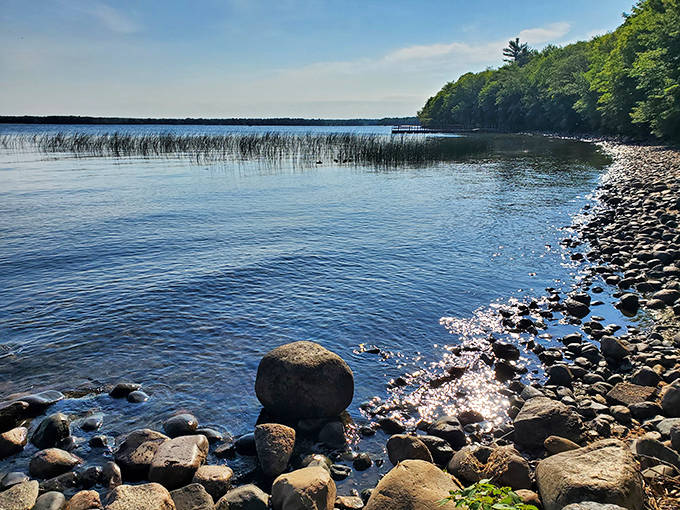 Nature's artwork displayed in stone along the rocky shoreline, where each wave polishes Minnesota's ancient geological history.
