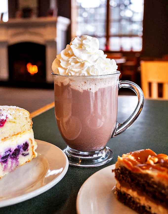 That hot chocolate isn't just a beverage &ndash; it's a work of art, crowned with whipped cream and paired with tempting cake slices.