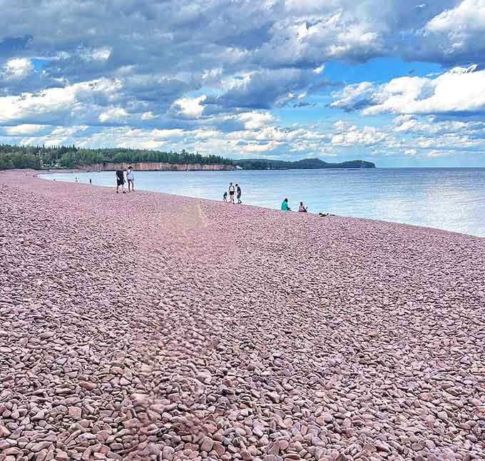 Visitors pause to experience the beach's famous "singing" &ndash; that delicate tinkling sound when waves retreat across the stones.