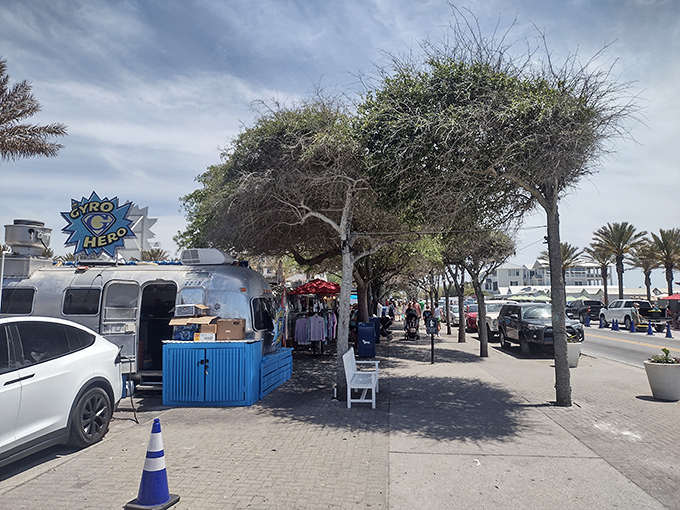 The brick-paved walkway guides food lovers between culinary destinations, with shady trees providing relief from the Florida sunshine.