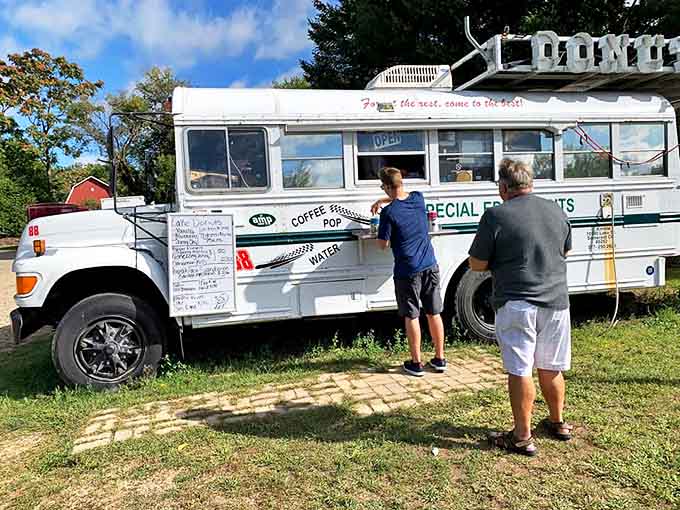 The universal language of donut anticipation – patiently waiting for that box of handcrafted happiness.