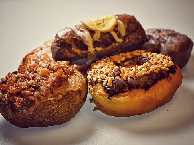Specialty Donuts: A quartet of creative genius featuring bacon, chocolate, and nuts &ndash; proof that donuts can be both comfort food and cutting-edge cuisine.