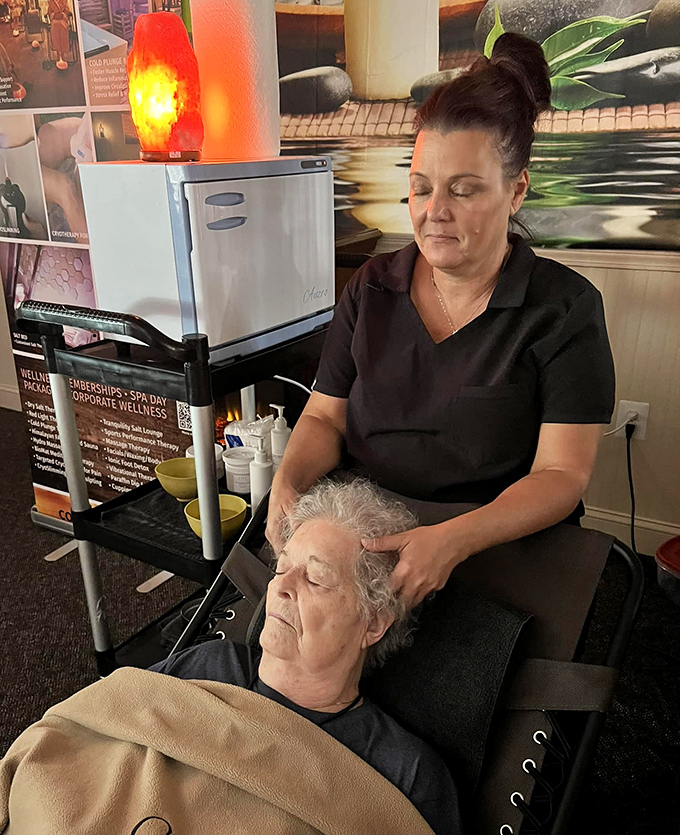 A therapist provides a specialized scalp treatment, combining traditional techniques with the spa's signature salt-infused products.