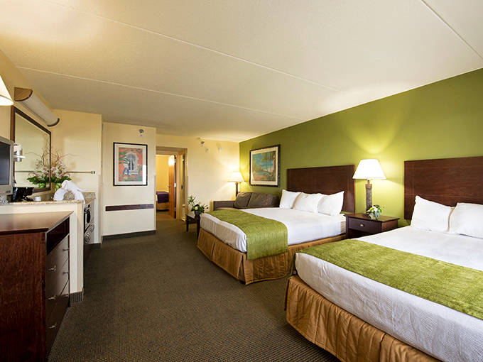 Comfortable rooms with splashes of green bring nature indoors, providing enough space for families to spread out wet towels without creating that locker room atmosphere.