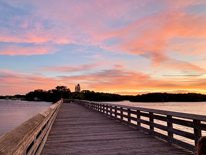 Sunset paints the sky in cotton candy colors, transforming the wooden pier into front-row seating for nature's nightly show.