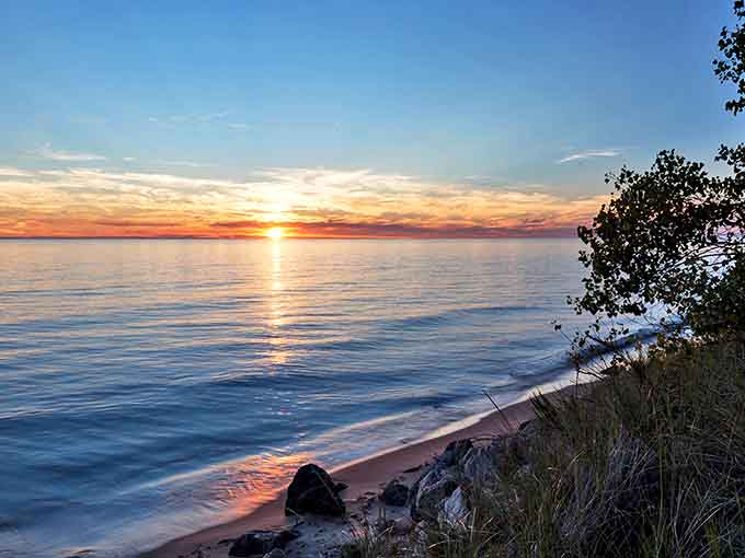 Lake Michigan sunsets perform a daily light show that turns the water into liquid gold, making photographers weep with joy.