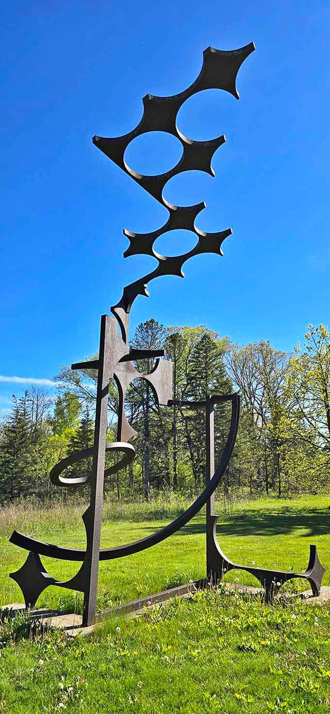 Reaching skyward like a cosmic antenna, this intricate metal sculpture seems to be communicating with something far beyond our atmosphere.
