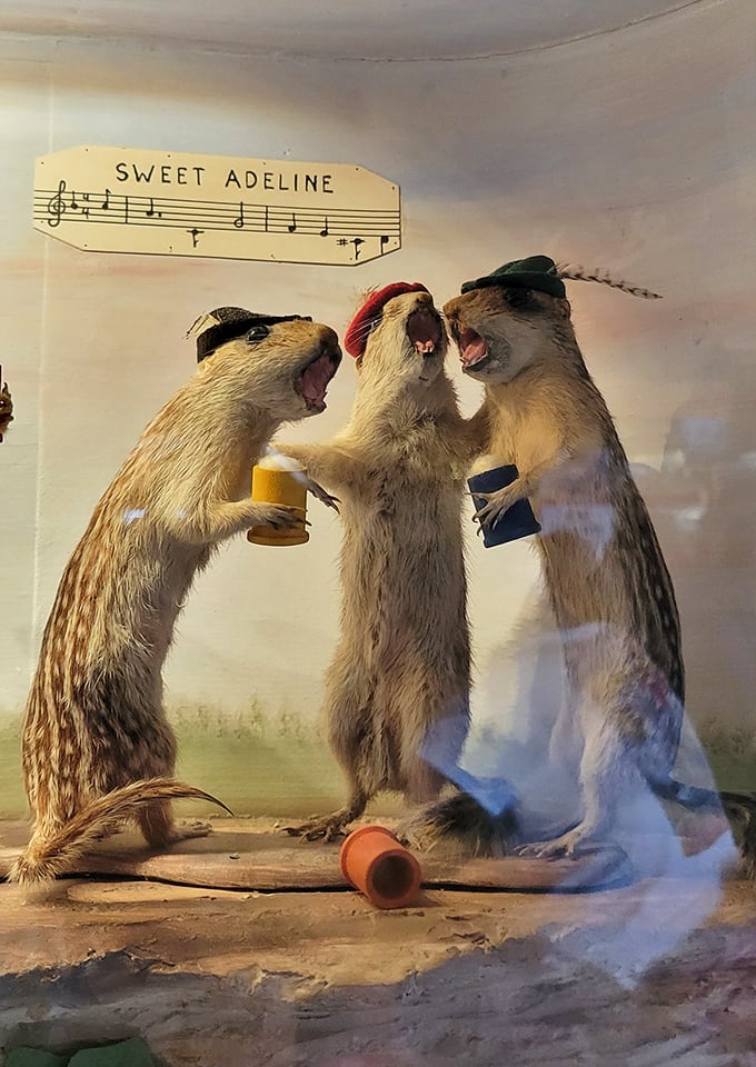 The singing weasels display captures the spirit of after-hours revelry, frozen in time for patrons to enjoy for generations.