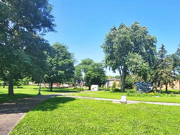 Lush greenery creates the perfect backdrop for the sculptures, with pathways inviting exploration through this artistic wonderland.