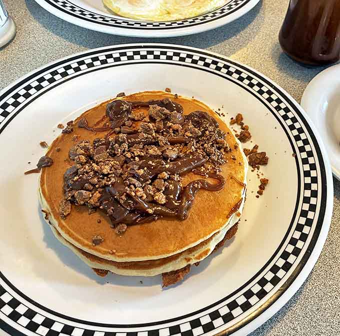 Pancakes that deserve their own fan club &ndash; fluffy, golden discs topped with chocolate and crumbled candy that make breakfast feel like a celebration.