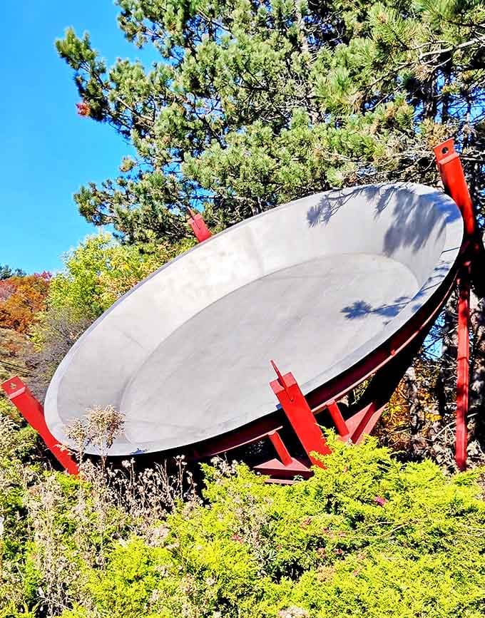 Sunlight plays across the concrete surface, highlighting the sheer audacity of a town that said, "Yes, we need a 17-foot pie pan."