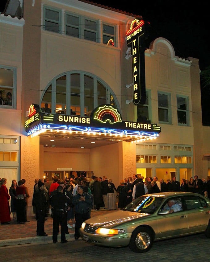 Night transforms the Sunrise into a beacon of culture, its illuminated sign drawing crowds like moths to a flame of entertainment.