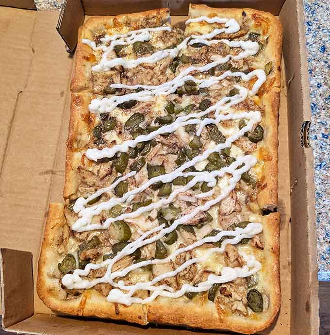 Not your average pizza&mdash;this chicken shawarma creation with its drizzle of white sauce represents the beautiful cultural fusion happening in Michigan's food scene.
