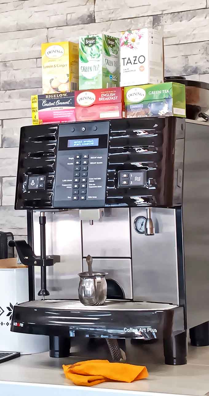 The coffee station stands ready for action, armed with an arsenal of teas and a serious machine that means business about your caffeine needs.