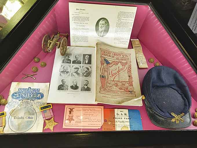 Civil War memorabilia, including medals, documents, and a Union cap, highlight connections between Mac-A-Cheek's history and pivotal moments in American history.