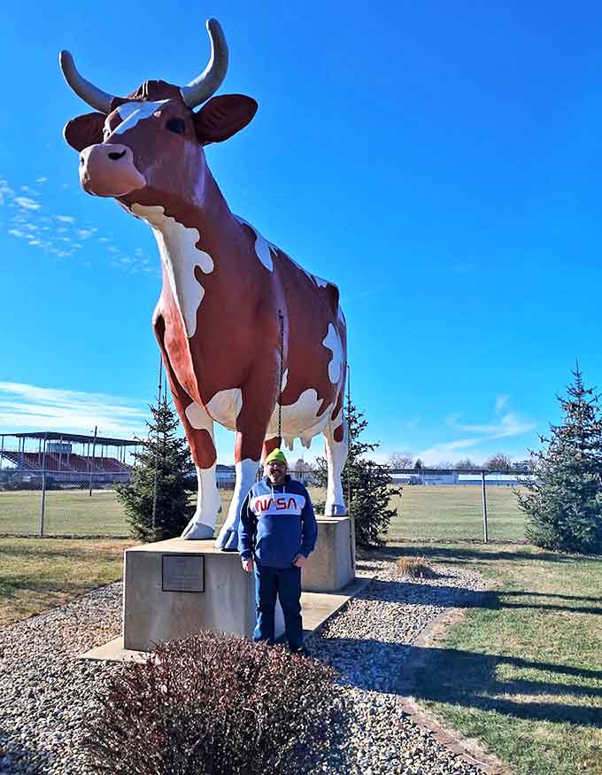 Against a brilliant blue sky, Buffy towers over her visitor &ndash; proving that in Wisconsin, even the cows aim for the stars!