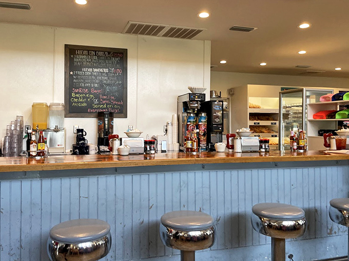 At the counter, breakfast dreams come true as coffee mugs stand ready for refills and pastries tempt from nearby.