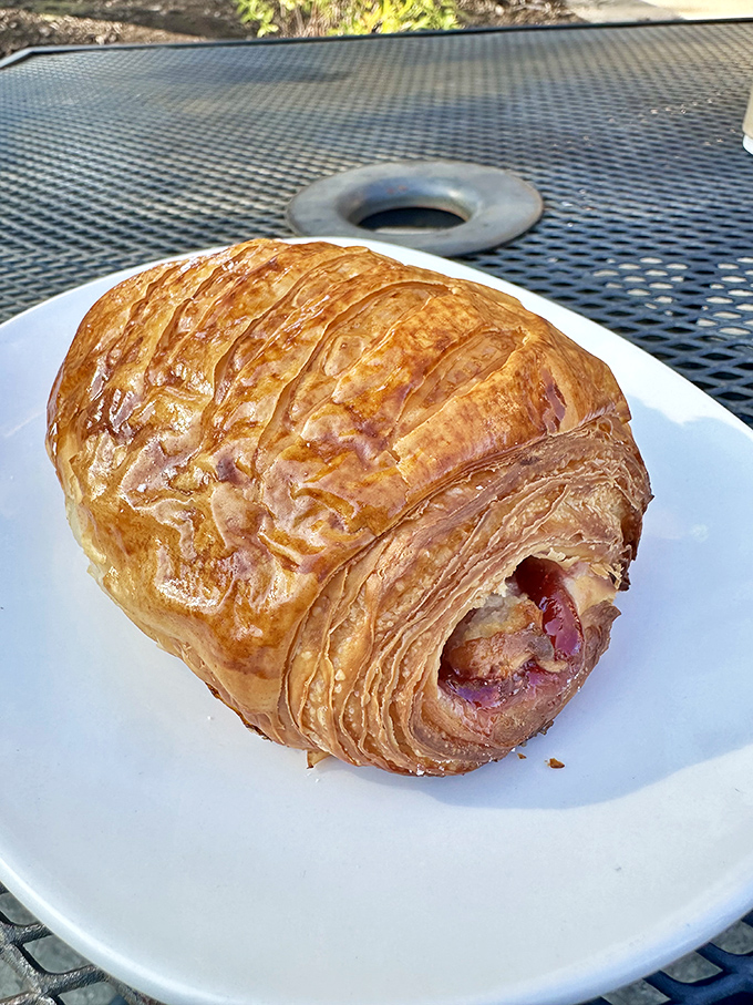 This ham-filled croissant represents breakfast engineering at its finest &ndash; buttery, flaky architecture housing savory treasures within.