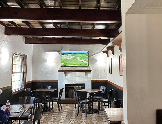A cozy corner with a fireplace and television offers a more intimate setting for enjoying your meal while watching the game.
