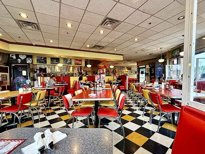 The checkerboard floor plays visual jazz beneath tables where memories are made one pancake stack at a time.