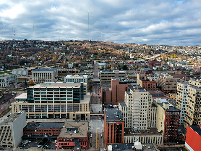 The city sprawls beneath moody skies, its grid of streets telling stories of industrial heritage and modern reinvention.