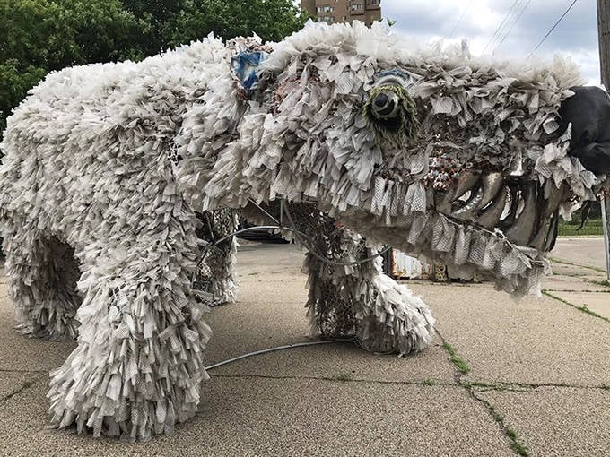 This massive polar bear-like creation, covered in plastic strips, demonstrates how everyday materials can transform into powerful artistic statements.