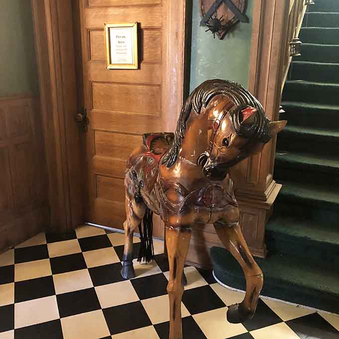 This hand-carved carousel horse has probably witnessed more castle history than most tour guides, standing sentinel in the grand entrance hall.