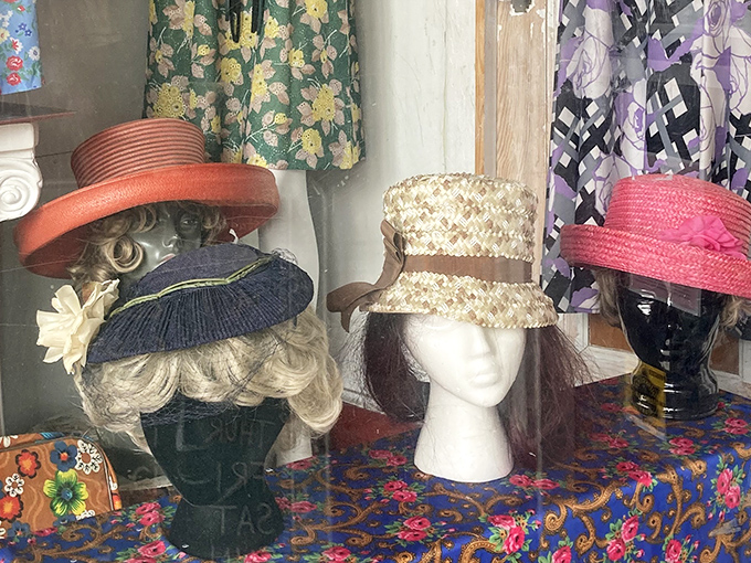 A congregation of vintage hats perched on mannequin heads &ndash; silent sentinels of style from eras when no outfit was complete without proper headwear.