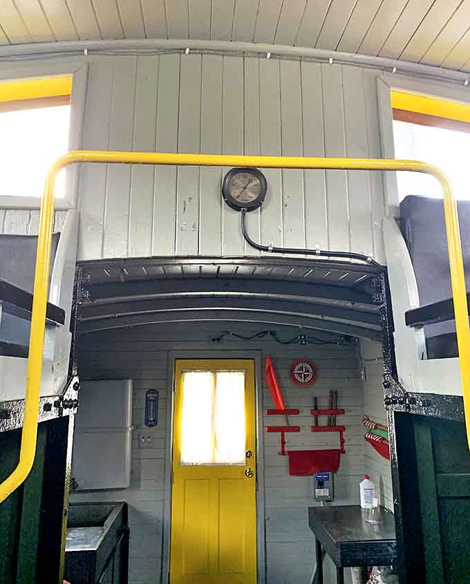 Inside the caboose, every detail serves a purpose. That yellow door probably leads to adventures the average commuter will never experience.