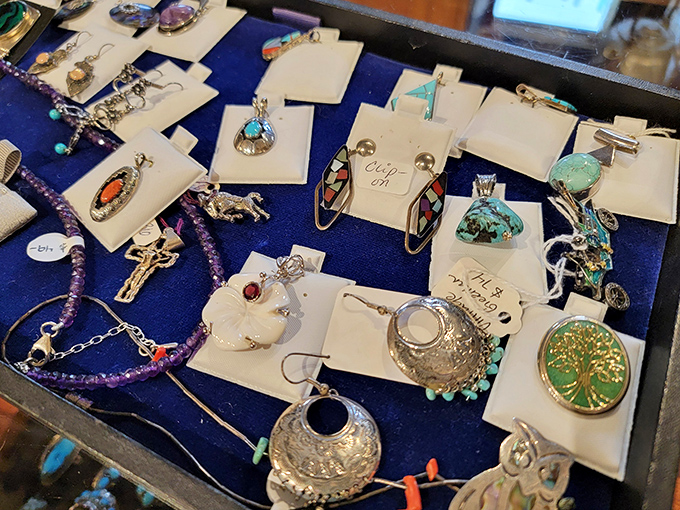 Silver pendants and turquoise stones arranged like an elegant buffet of wearable history – each piece waiting for its next adventure.