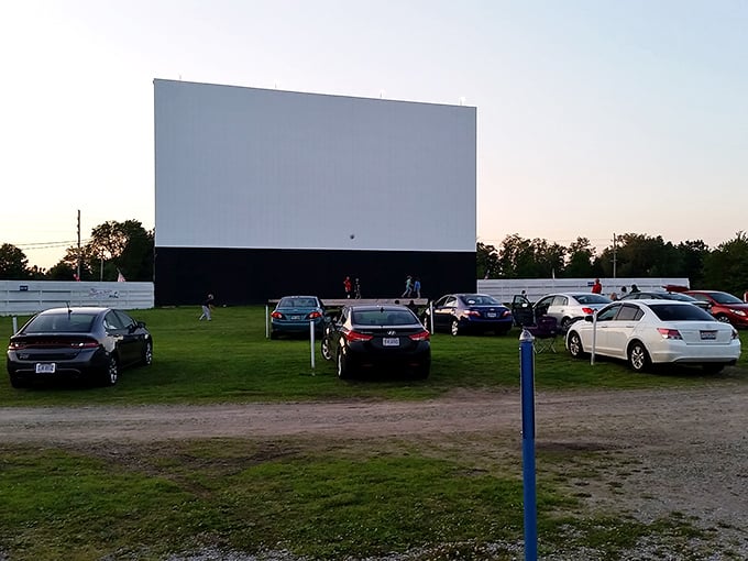 Cars gather in anticipation as the massive screen awaits dusk &ndash; each vehicle a private theater with the best seats in the house.