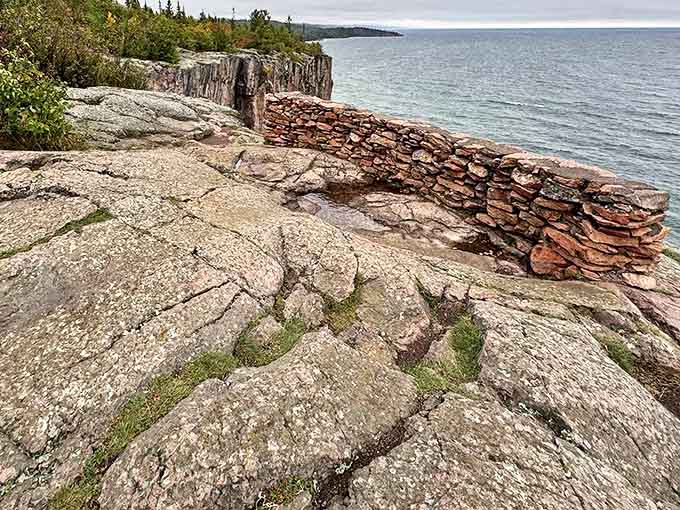 The main overlook area showcases ancient stonework against the backdrop of Lake Superior, where billion-year-old rock meets endless water.