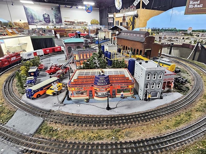 A vintage paddlewheel steamboat shares the waterways with the trains, highlighting the interconnected transportation systems of yesteryear.
