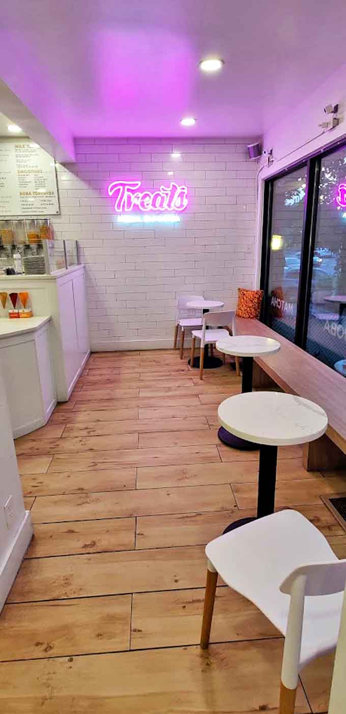 Clean lines, white subway tiles, and that iconic pink neon sign create an atmosphere that's both Instagram-worthy and genuinely inviting.