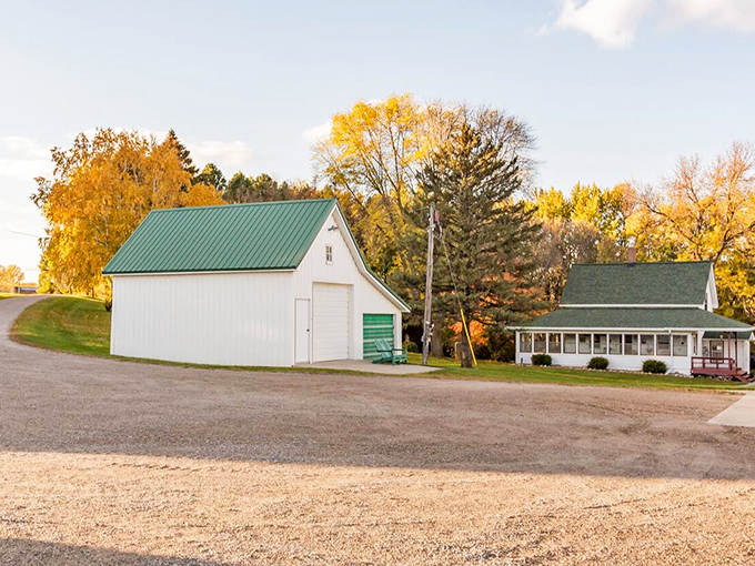 The farmhouse and its companion barn stand like sentinels against the backdrop of Minnesota's countryside, timeless and inviting.