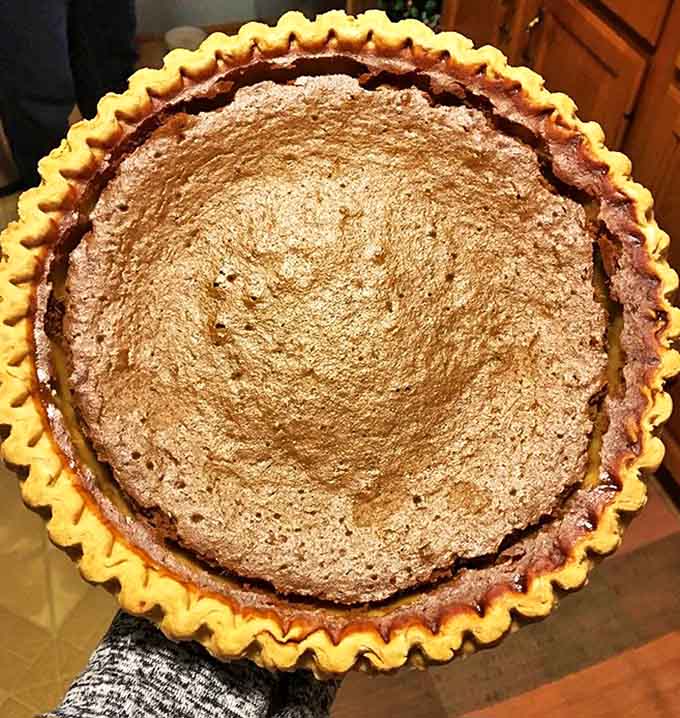 A homemade pie with a golden, flaky crust that whispers sweet promises of comfort with every perfectly spiced bite.