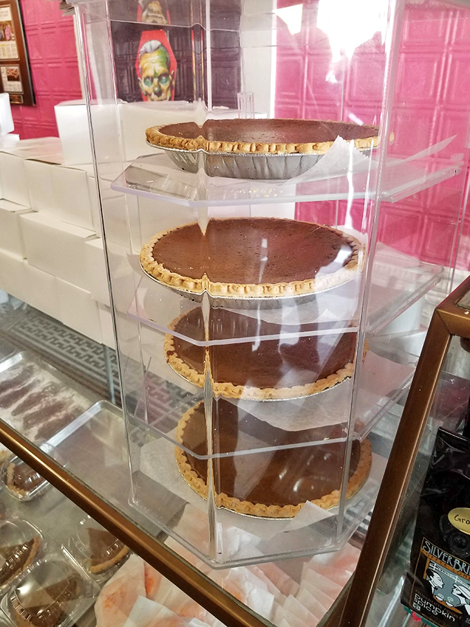 Pumpkin pies stacked like treasure in their clear fortress &ndash; each one a perfect circle of spiced velvet waiting to be claimed.