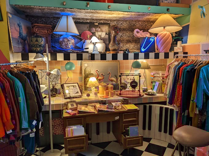 Piano keys frame this vignette of vintage clothing and mid-century lamps&mdash;like stepping into a Wes Anderson set designed by thrift store enthusiasts.