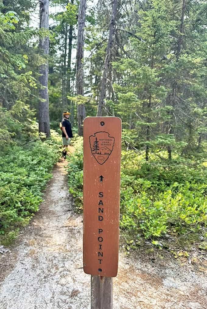 The National Park Service trail marker stands ready to guide visitors, its simple design proving that sometimes the best signage just points the way without unnecessary fuss.