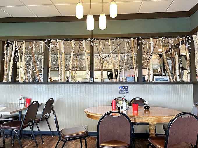 Clever birch branch dividers create intimate dining spaces while maintaining the restaurant's warm, communal atmosphere&mdash;pure Northwoods ingenuity.