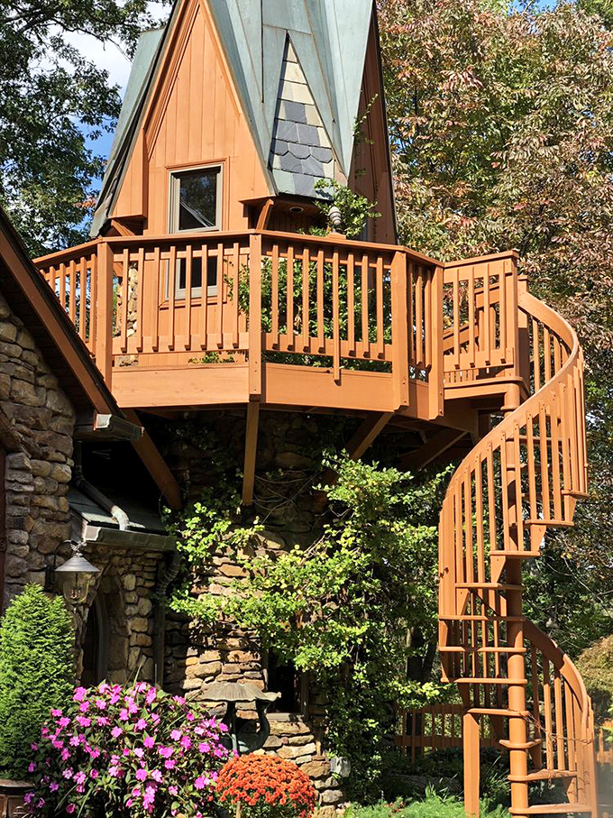 This spiral staircase isn't just functional – it's an Instagram moment waiting to happen, surrounded by vibrant flowers and stonework.