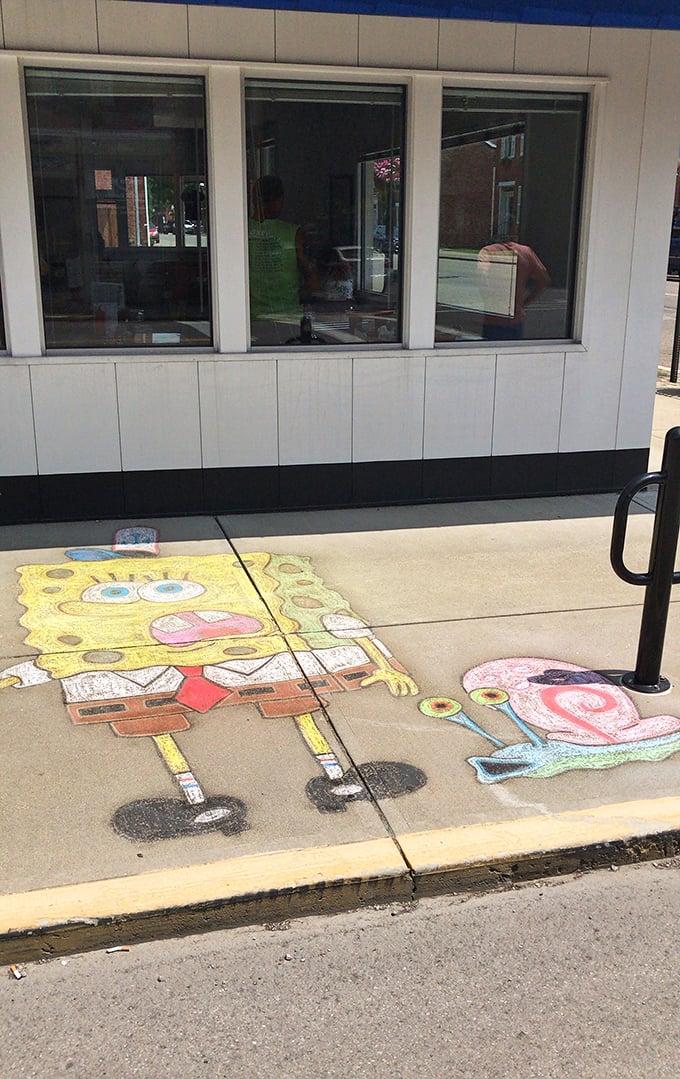 Sidewalk art outside Carl's adds whimsical charm to your approach &ndash; because the experience begins before you even step through the door.