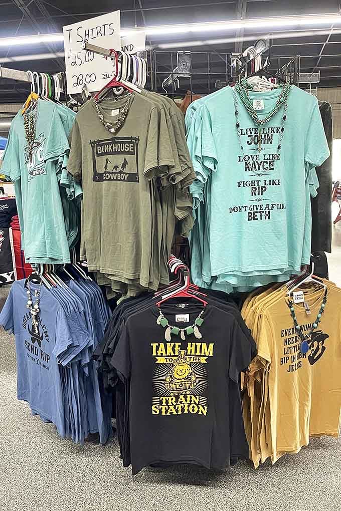 Wearable opinions and pop culture references hang in colorful rows. Nothing says "personality" quite like a t-shirt that makes strangers laugh.