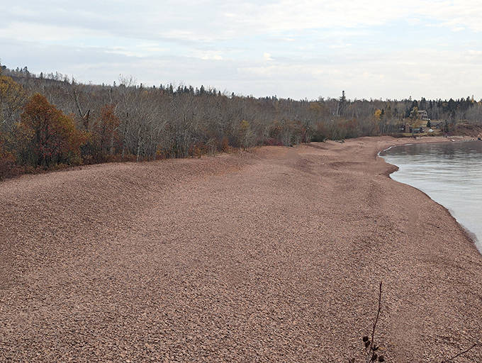 Aerial view reveals Iona's perfect crescent shape, carved by centuries of Lake Superior's patient artistry and geological wizardry.
