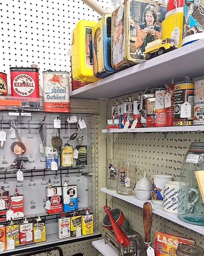 Colorful vintage oil cans and automotive collectibles line the shelves like a rainbow of nostalgia, reminding us when brand loyalty meant something and packaging was genuinely artistic.