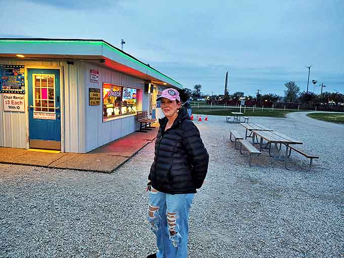 Bundled against the evening chill, this drive-in devotee knows the secret: the best theater seats have always been the ones you bring yourself.