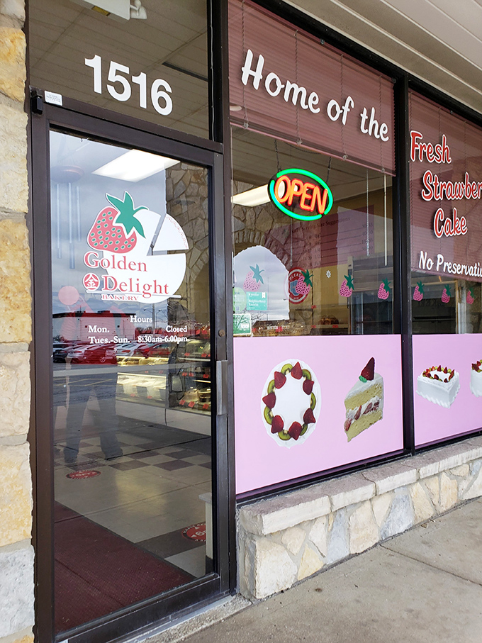 The inviting storefront promises sweet satisfaction with its cheerful signage and tempting window displays showcasing their signature cakes.