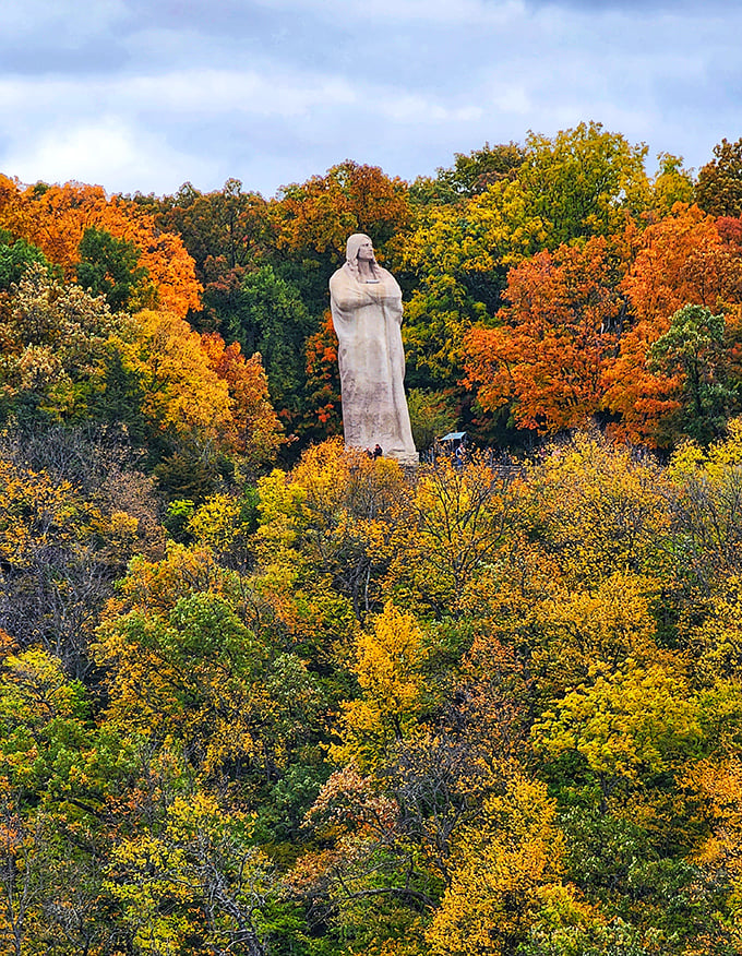 Autumn transforms the setting into a spectacular canvas of color, with the statue standing as a steadfast anchor amid nature's seasonal fashion show.
